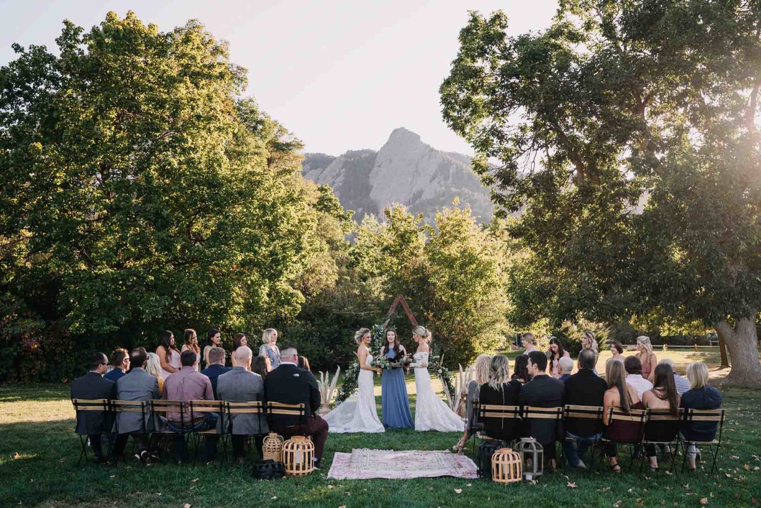 Laid-back Colorado mountain wedding with floral triangle arch
